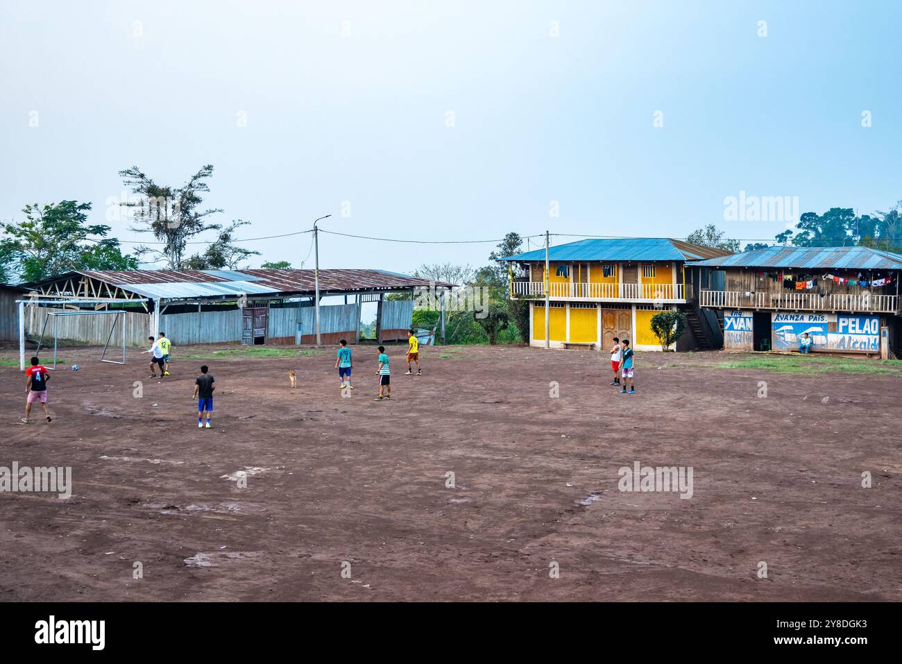A group of young men playing football in a remote village. Peru, South ...