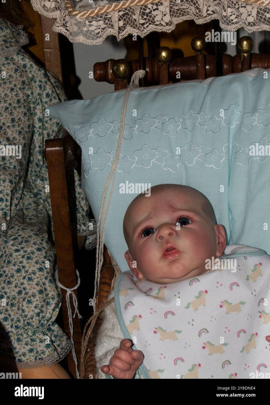 Realistic reborn baby doll lying in bed or cradle, pretty life-sized ...