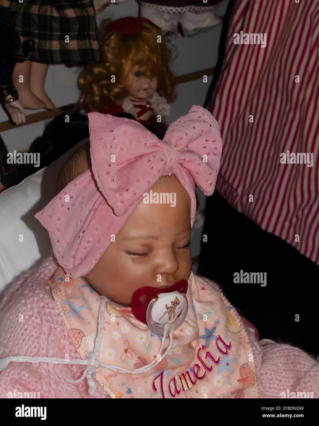 Asleep cute reborn baby doll wearing pink hair band with large bow ...