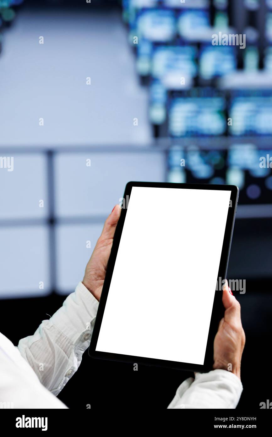 Close up shot of mock up tablet used by experienced serviceman in data center using server ...