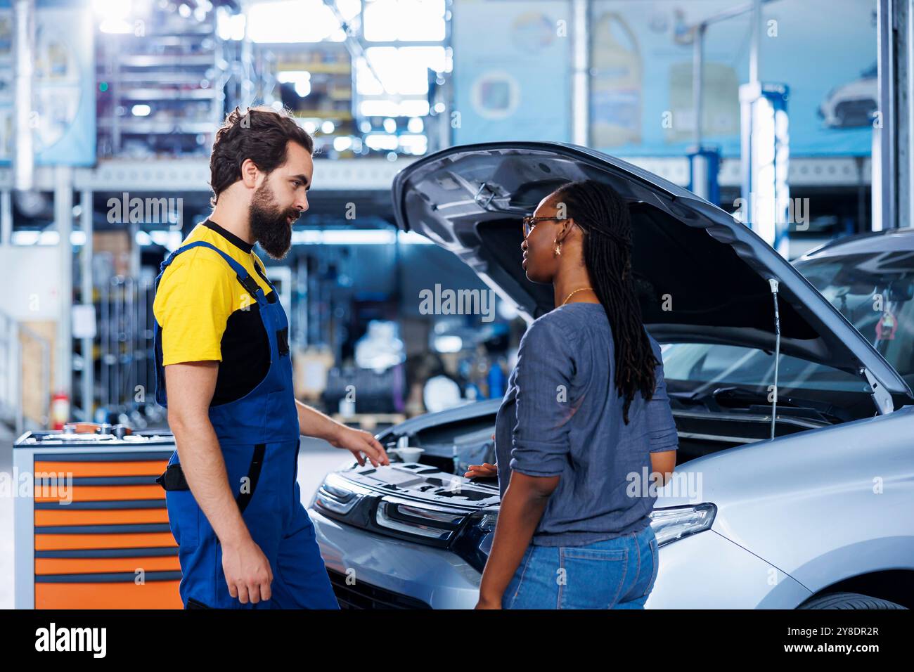 Mechanic at auto repair shop conducts annual vehicle checkup, informing ...