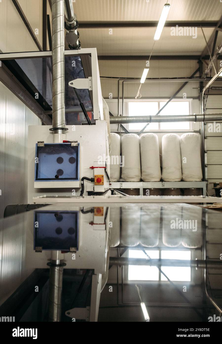 A large industrial machine with a dust collection system operates in a ...