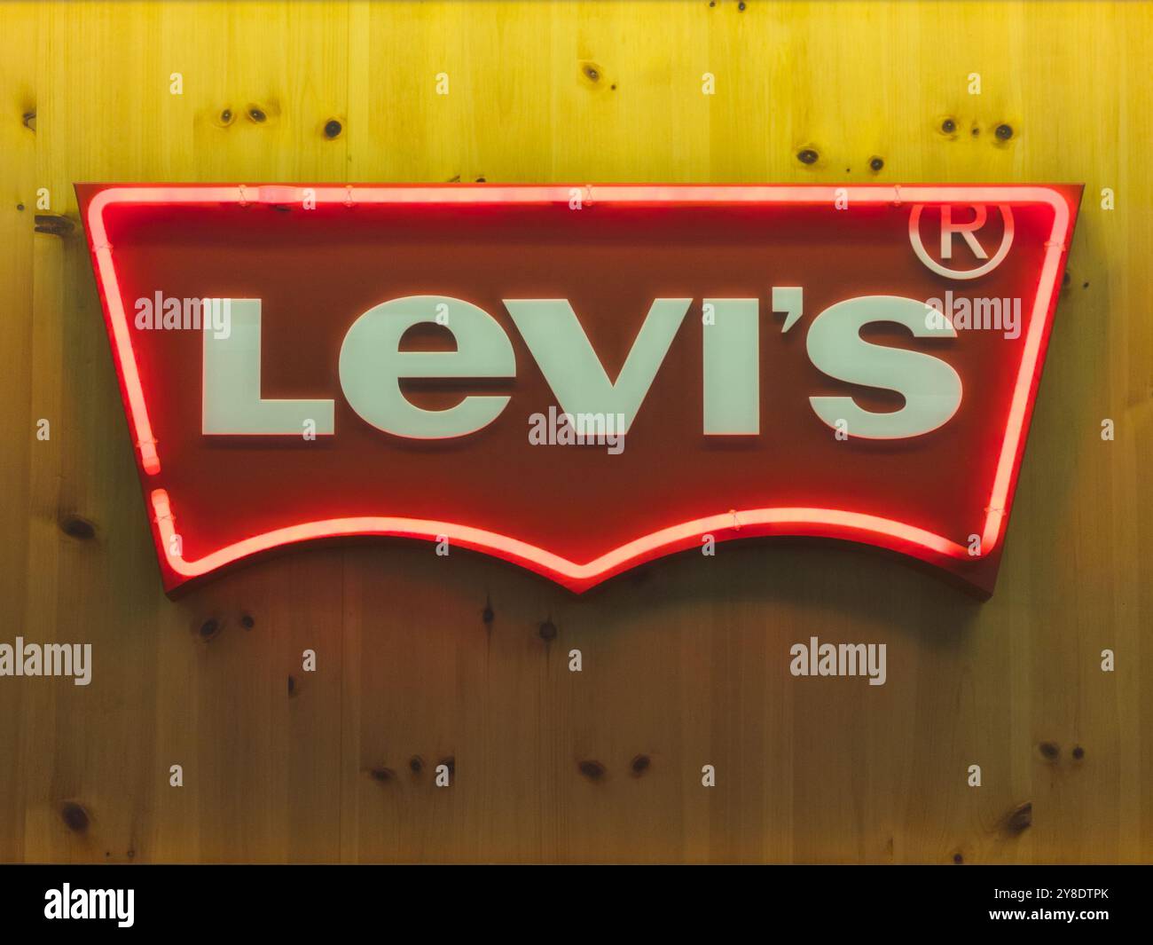 Red neon sign with the Levis emblem hanging in a retail clothing store ...