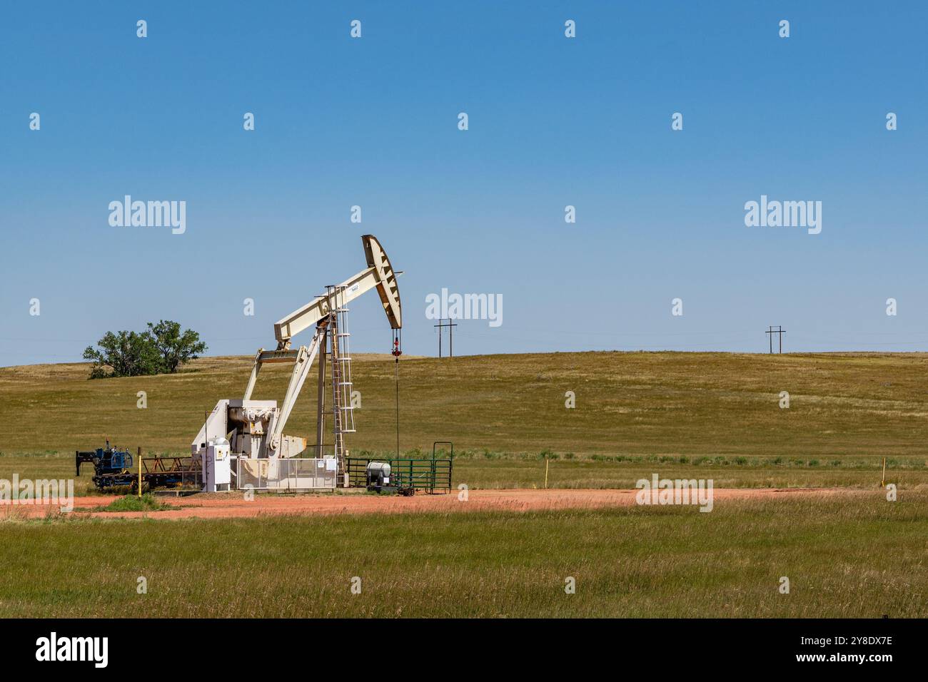 Small oil pump or derrick in field Stock Photo - Alamy