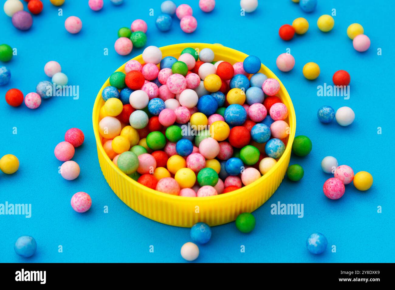 Colorful spheres concentrated in a circular area surrounded by others ...