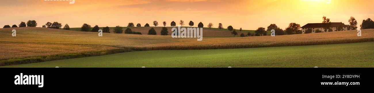 Wide banner panorama of a rural landscape. An idyllic farm on a hill ...