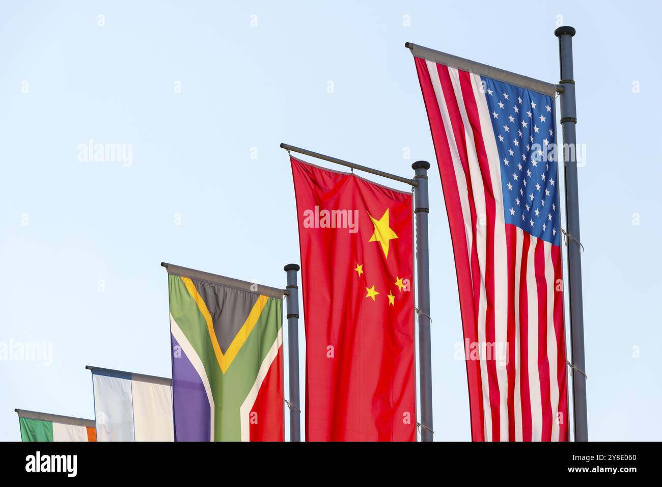 Various national flags fly on flagpoles against a blue sky, Chinese ...