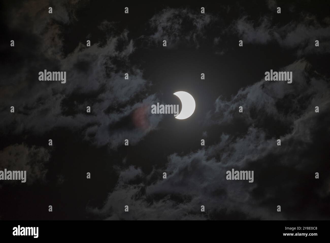 Partial solar eclipse with light cloud cover on 2 October 2024 in ...