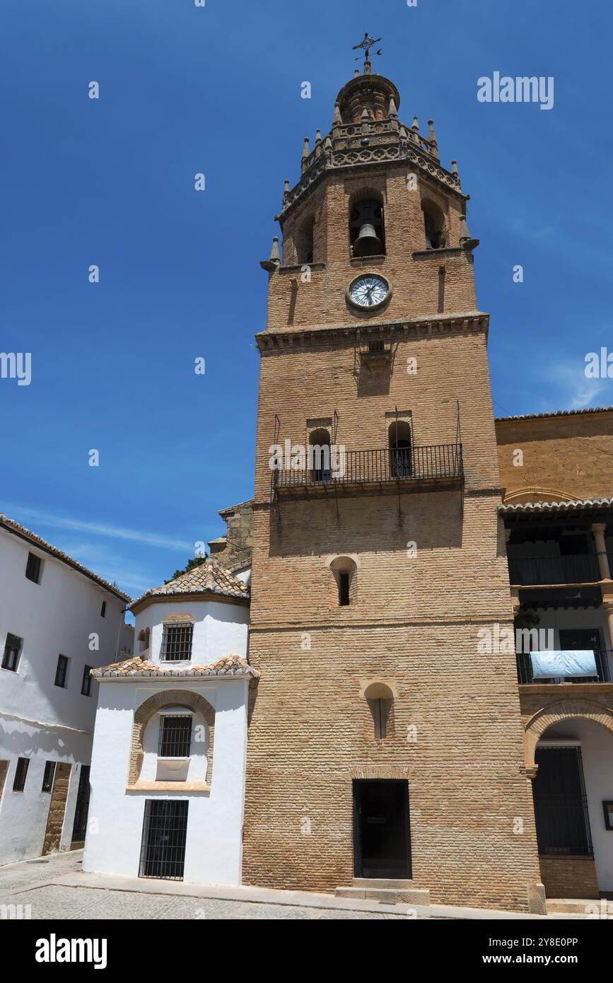 Historic brick church tower with clock in front of a clear blue sky in ...