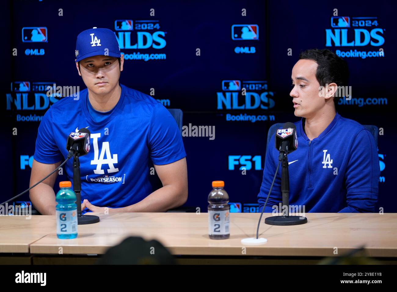Los Angeles Dodgers' Shohei Ohtani, left, speaks to reporters with his ...