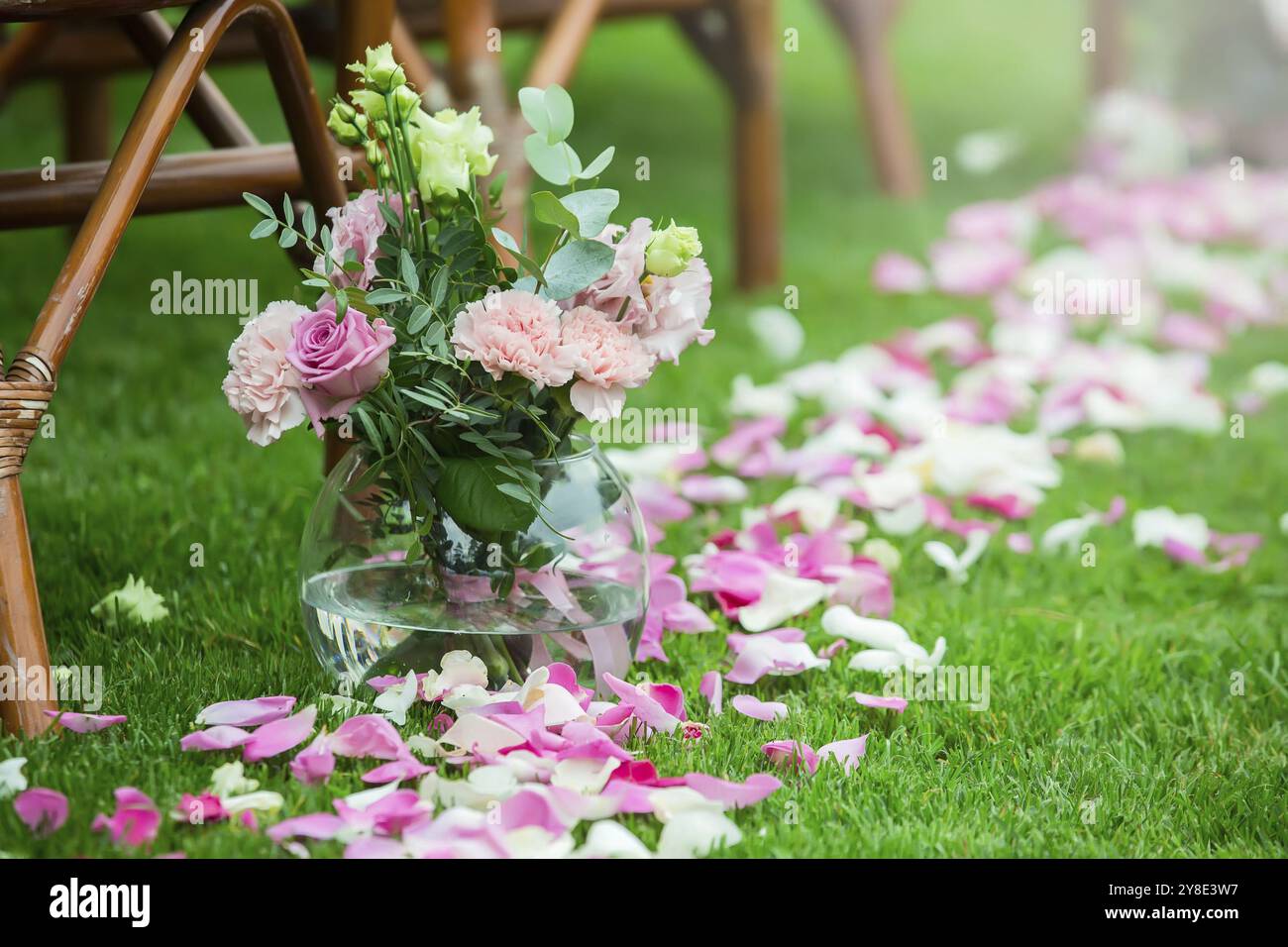 Outdoor wedding ceremony decoration setup. Path with petals, chairs ...