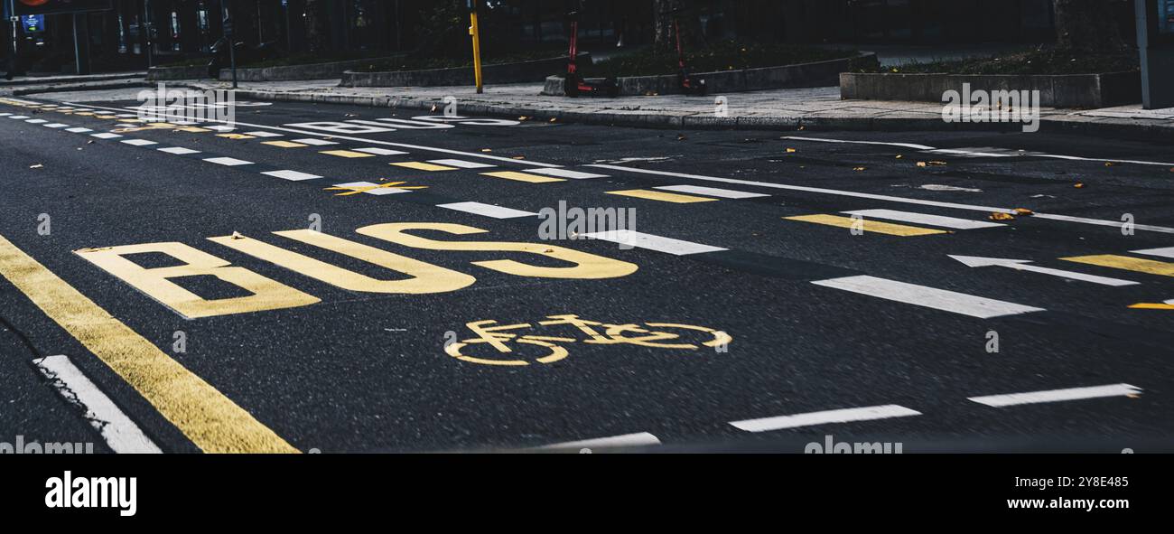 Street scene with marked bus and cycle lane on tarmac Stock Photo - Alamy