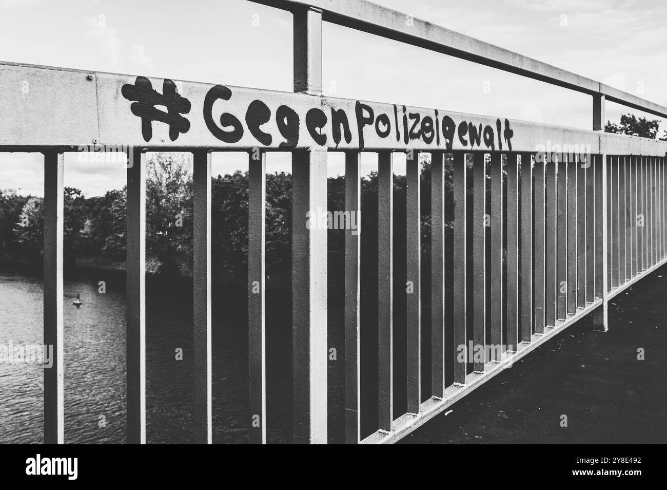Bridge with graffiti against police violence in black and white ...