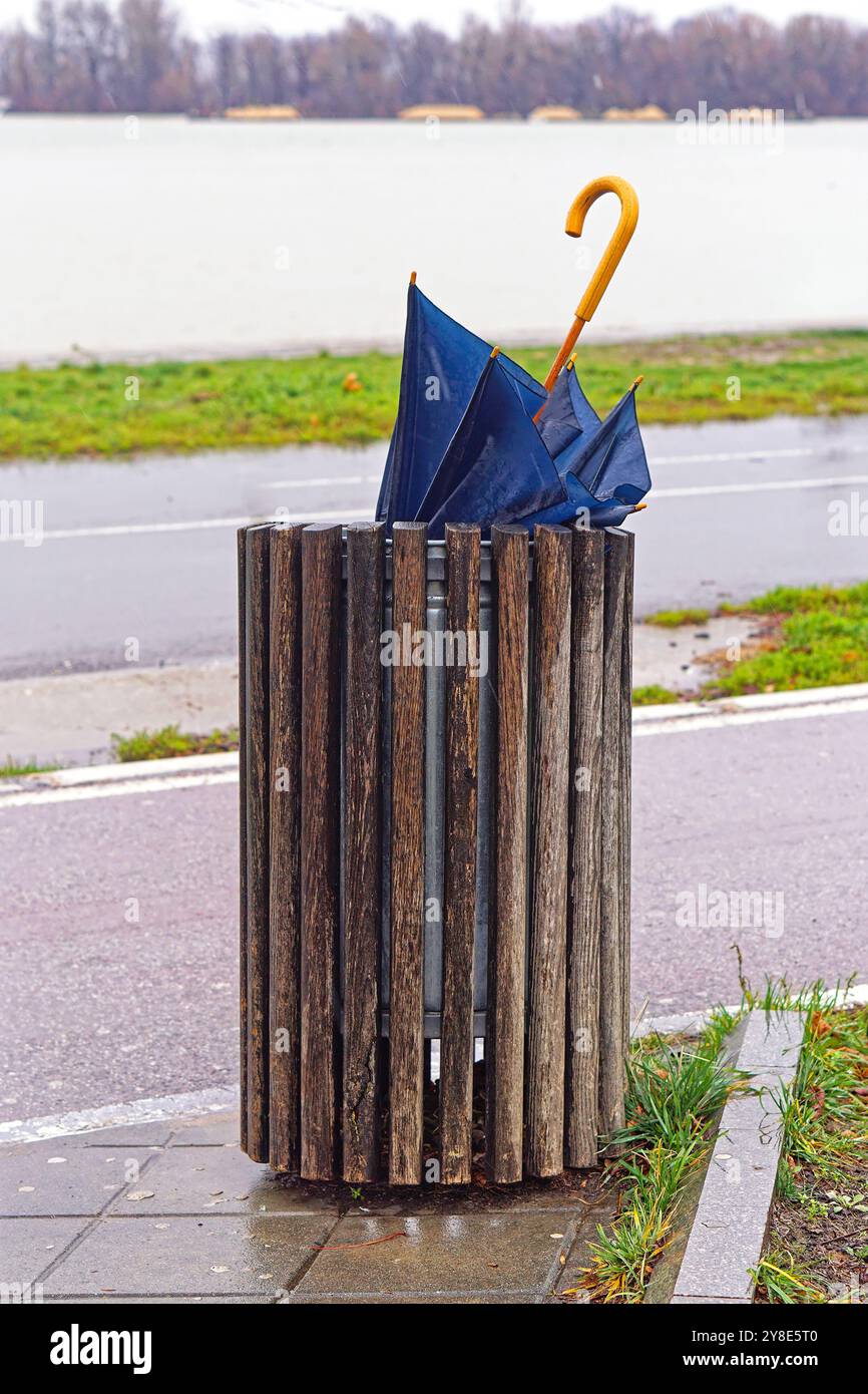 Broken wet umbrella in garbage trash bin rain day Stock Photo - Alamy