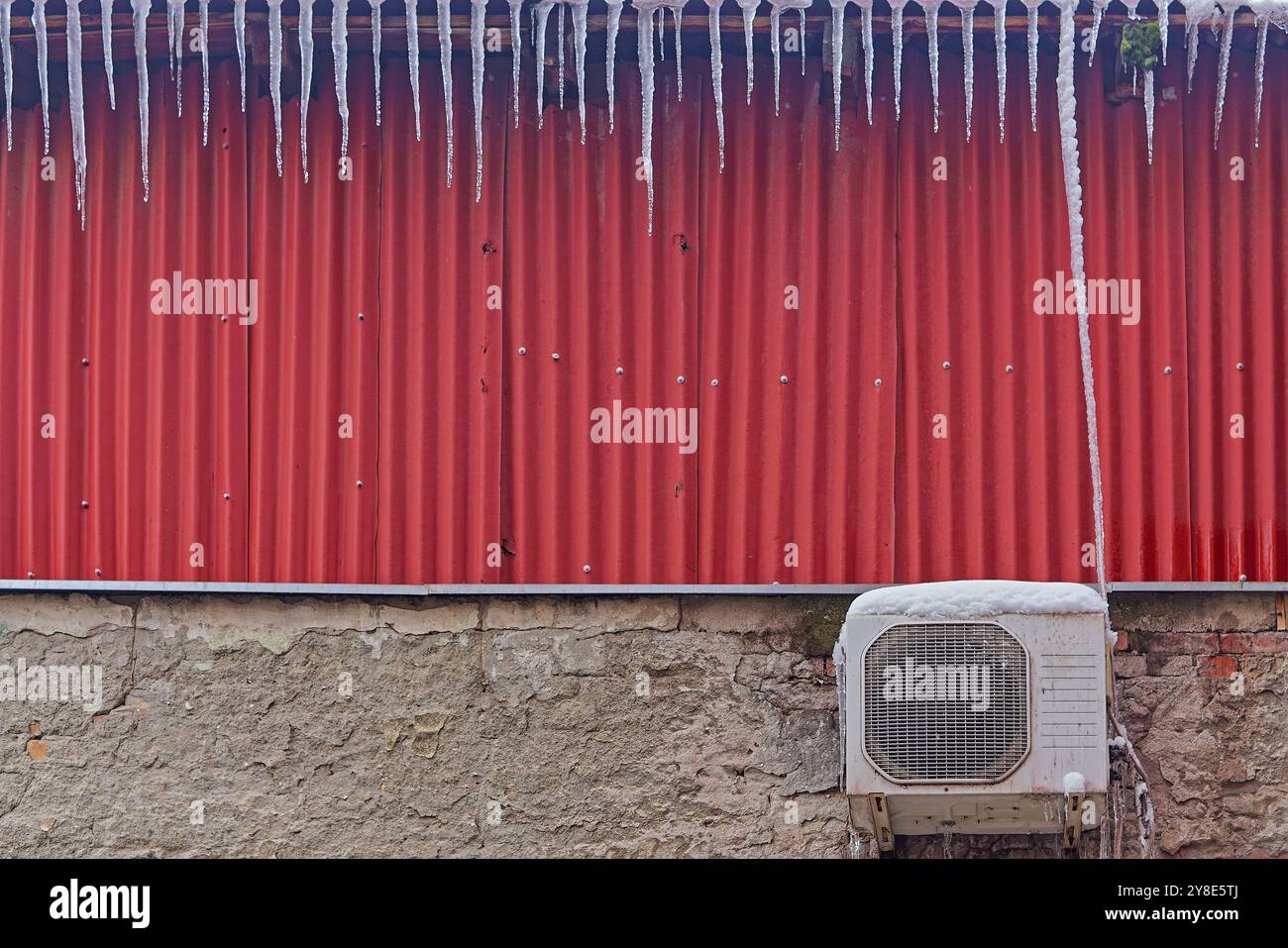 Frozen air Conditioner unit dangerous icicles hang from building roof ...