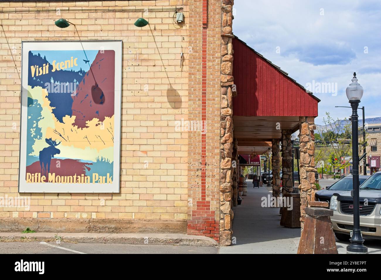 Tourism wall art on alleyway side of brick commercial building in ...