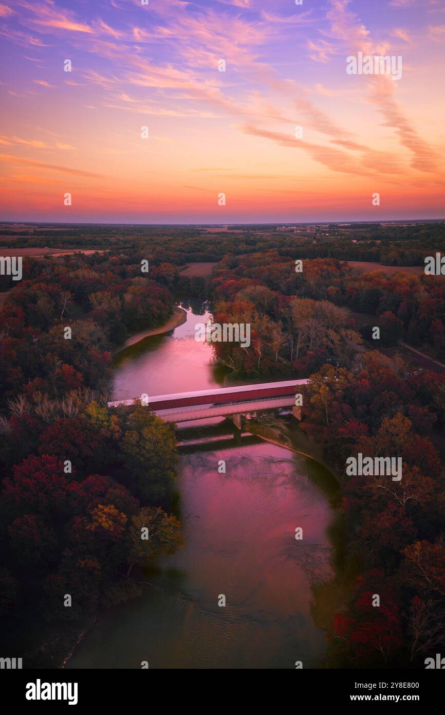 A vibrant sunset facing towards a new paved bridge next to a historic ...