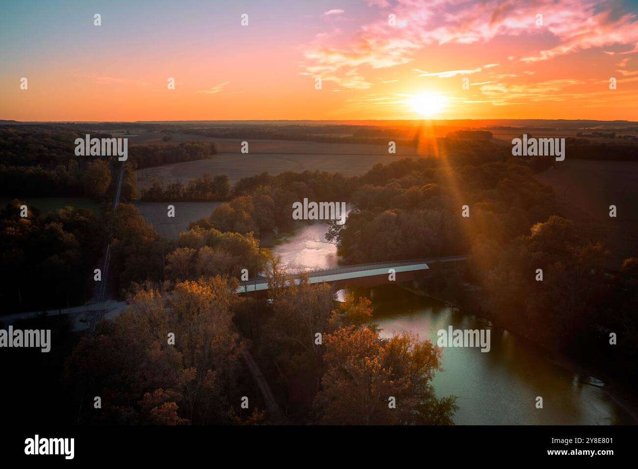The setting sun as it appears above the white river in Southern Indiana ...