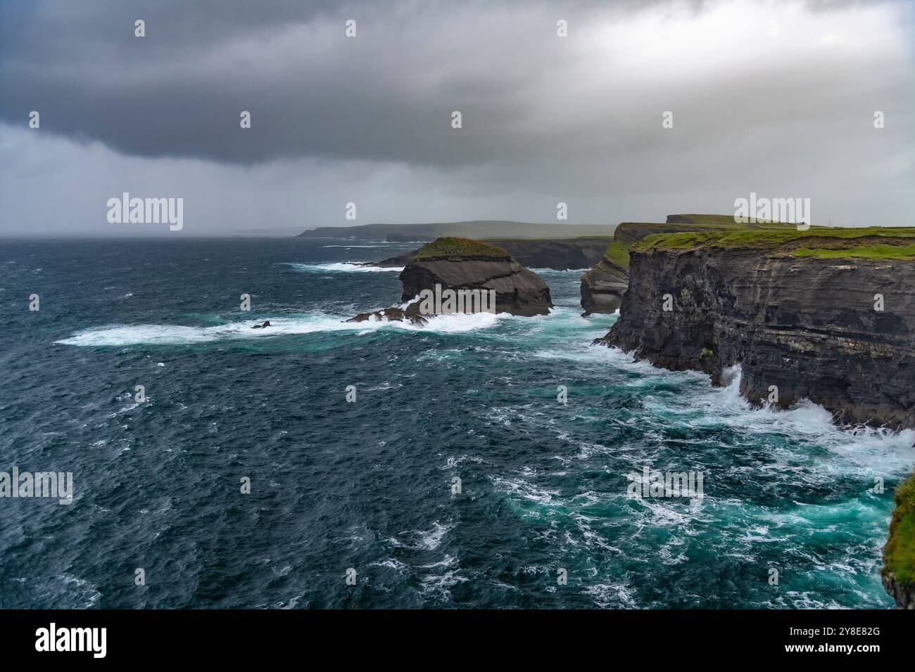 Rugged Coastal Cliffs with wild Atlantic ocean waves clashing against ...