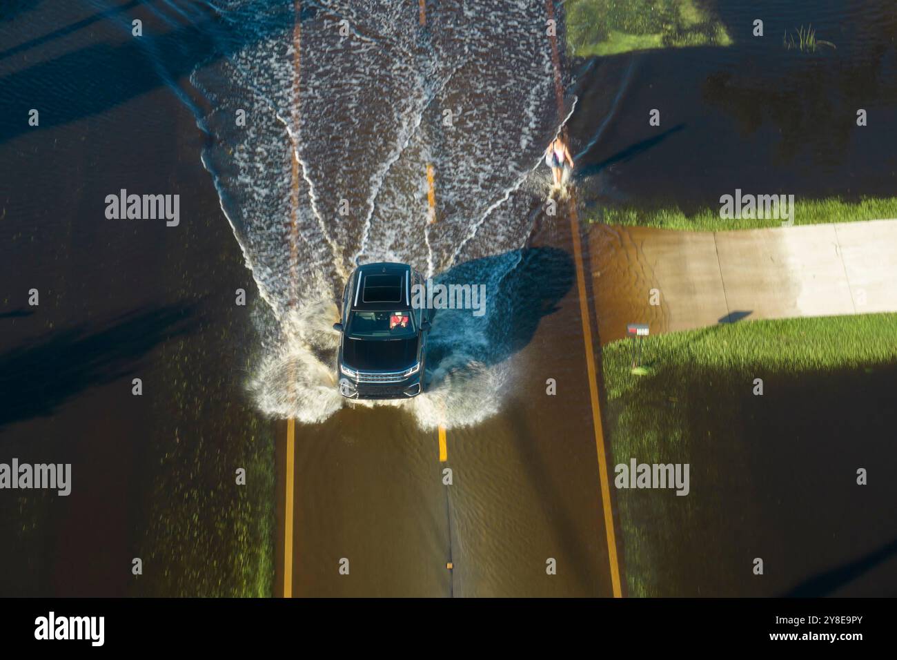 Aerial view of flooded street after hurricane rainfall with driving ...