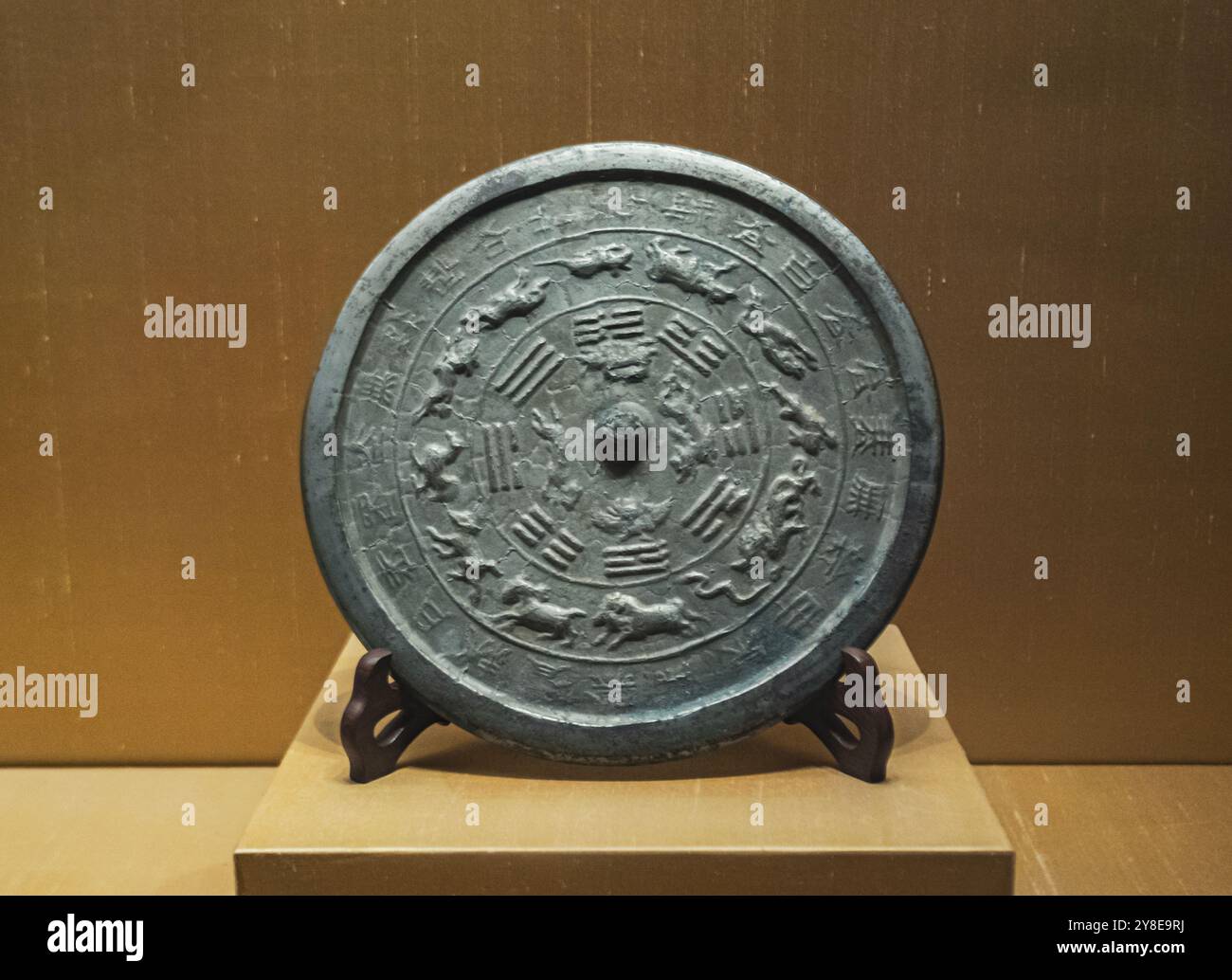 An ancient Chinese bronze mirror with intricate carvings of animals and ...
