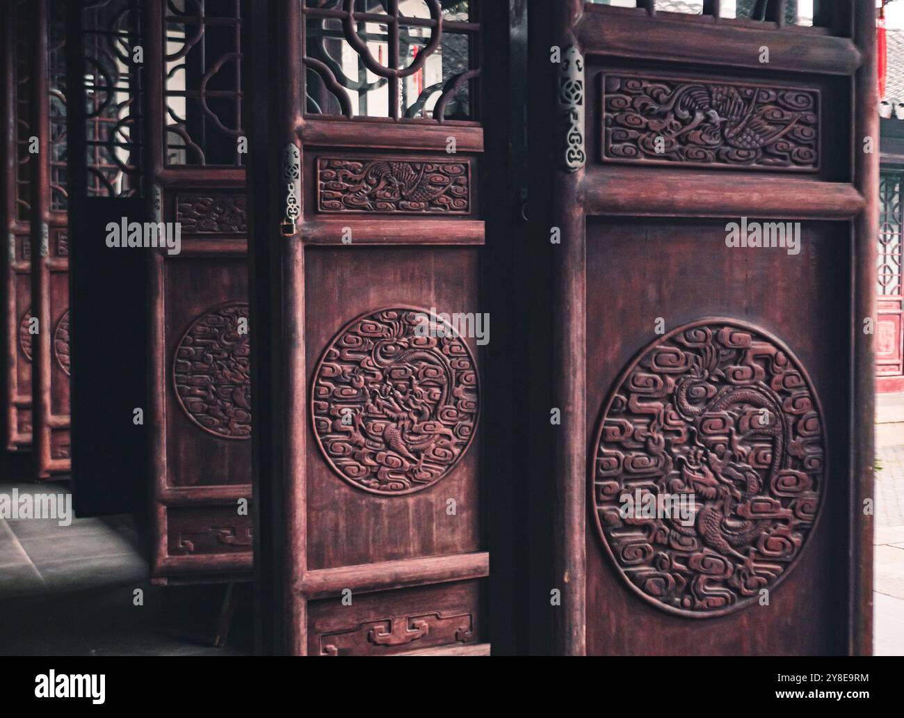 Intricately carved wooden doors in a traditional Chinese architectural ...