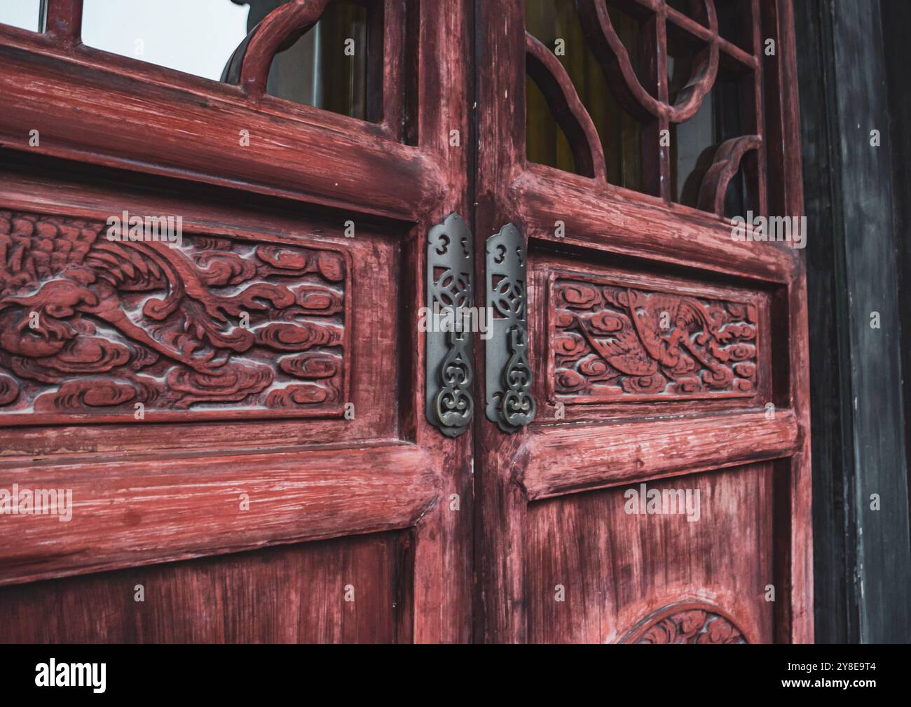 Intricately carved wooden doors at a historic Asian building showcasing ...