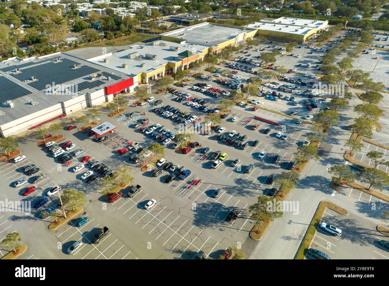 Aerial view of many cars parked on parking lot in front of a grocery ...