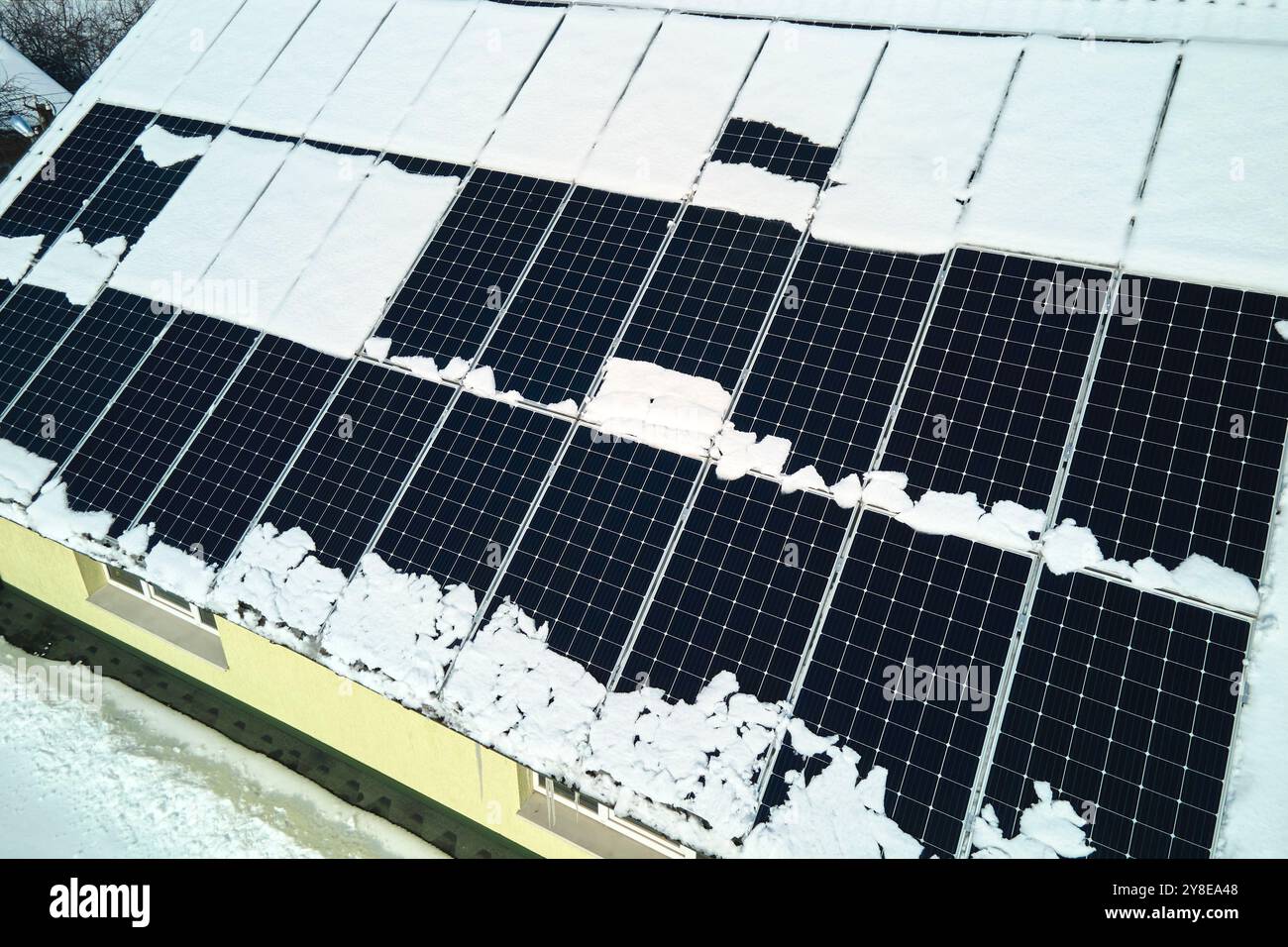 Aerial view of snow melting from covered solar photovoltaic panels ...