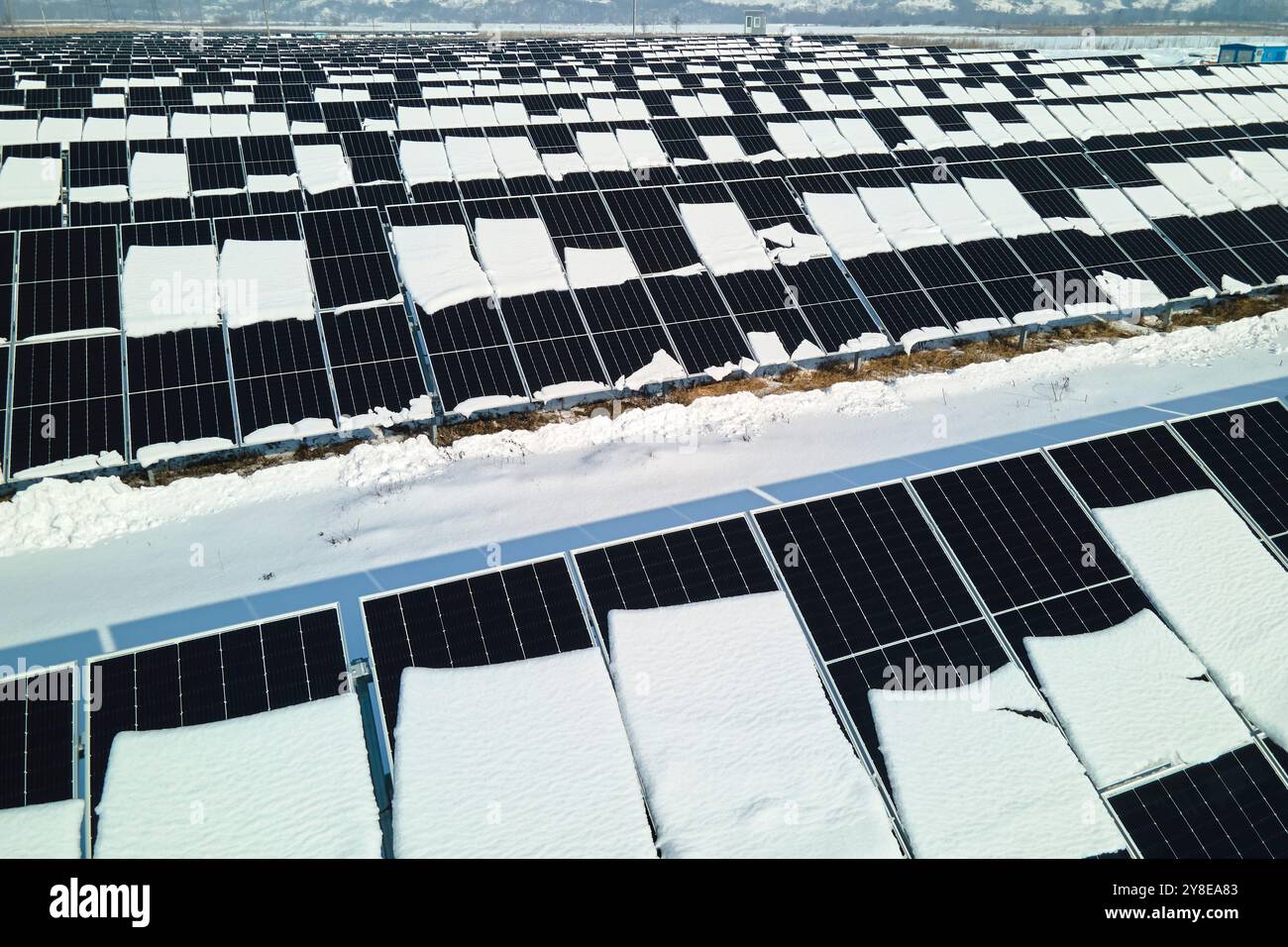 Aerial view of snow melting from covered solar photovoltaic panels at ...