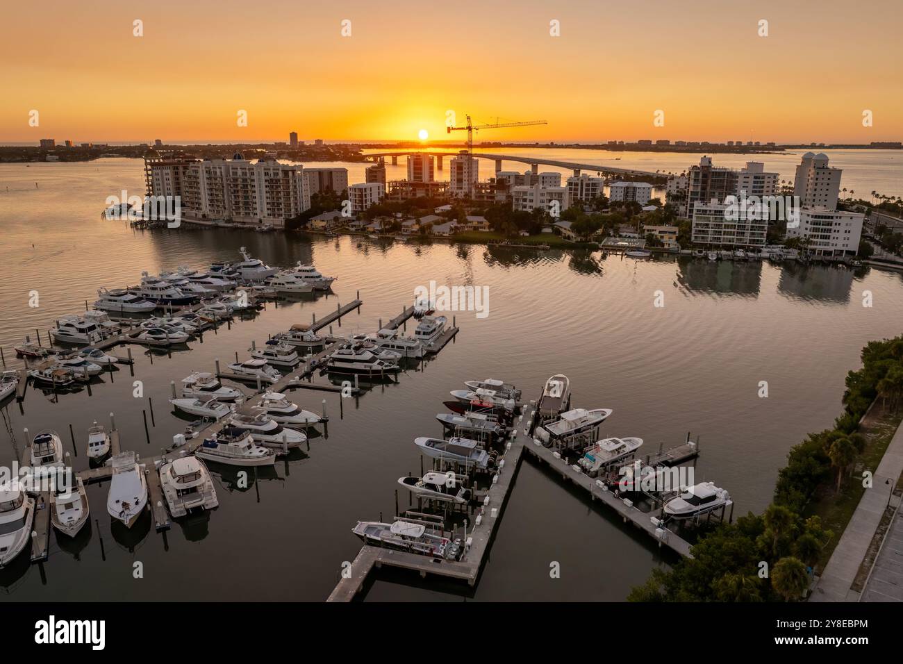 Aerial view of Sarasota city downtown at sunset with bay marina yachts ...