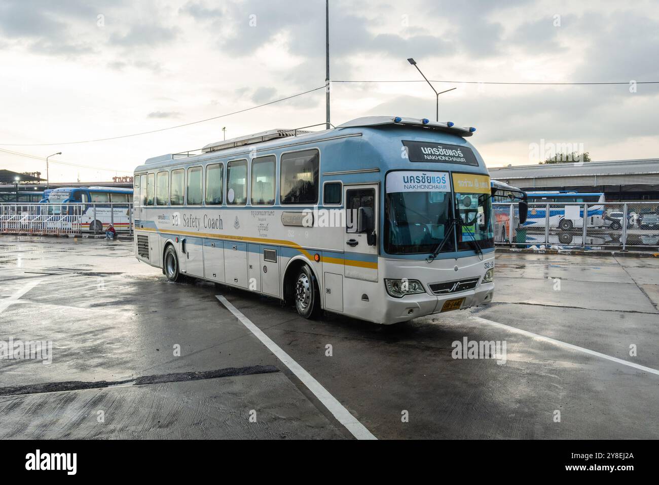 A view at dusk of a double-decker bus arriving at Mo Chit Bus Terminal ...