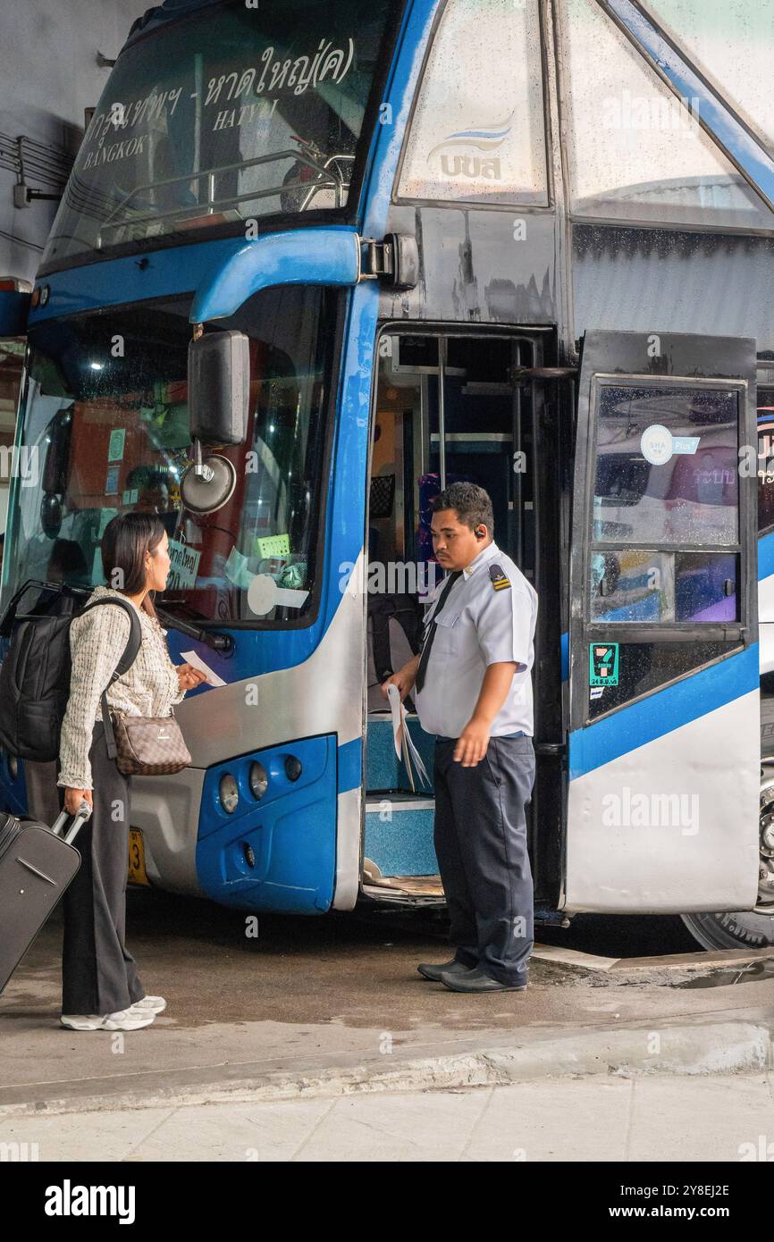 A driver is seen checking a passenger ticket, at the entrance of a double-decker bus, at Mo Chit ...