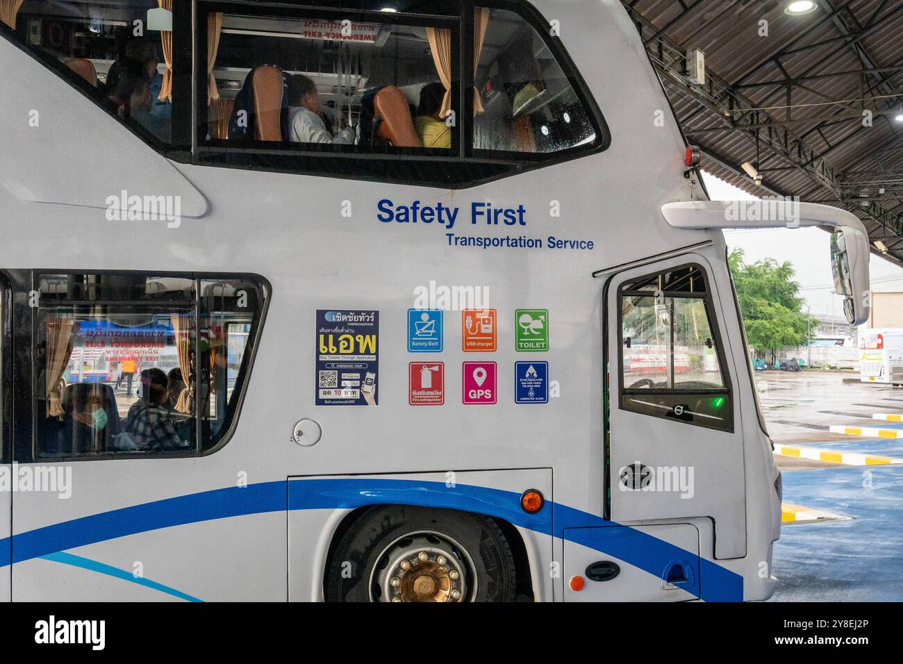 A close view of passengers inside a double-decker bus, with the ...