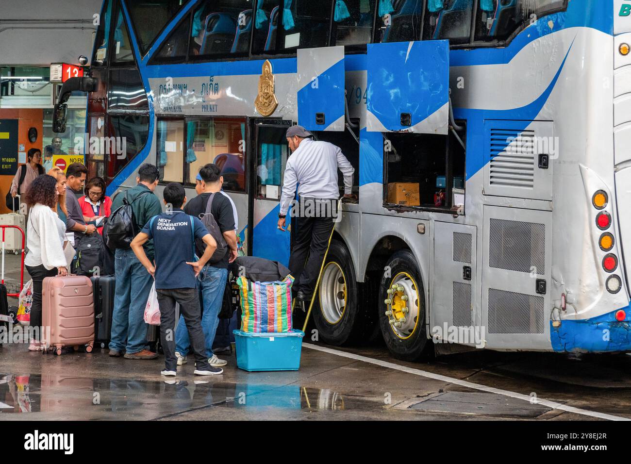 A double-decker bus driver is seen using a ladder to place passengers ...