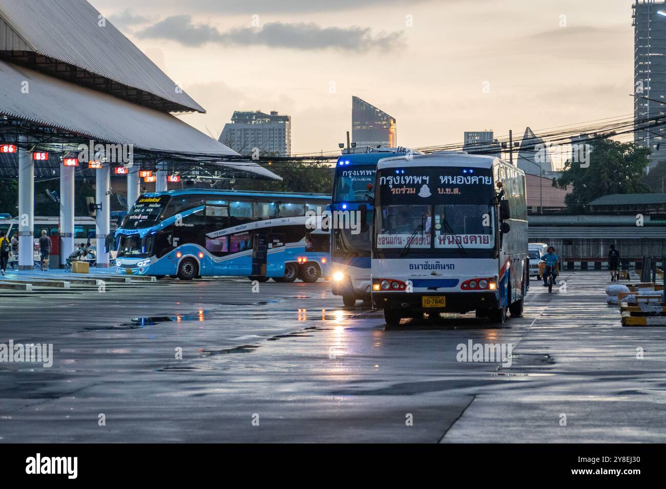 A large view of double-decker buses for departures, at dusk, at Mo Chit ...