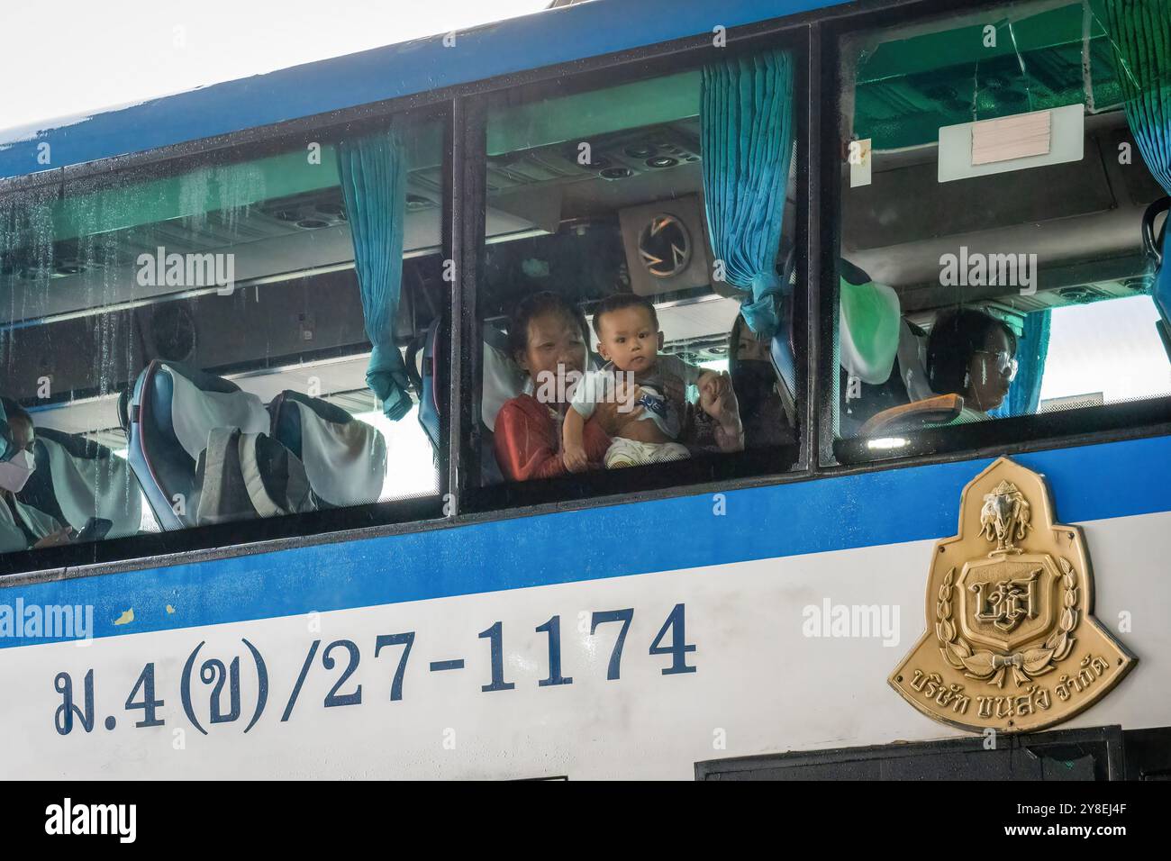 A close-up inside a double-decker bus of a woman and her baby, before departure, at Mo Chit Bus ...