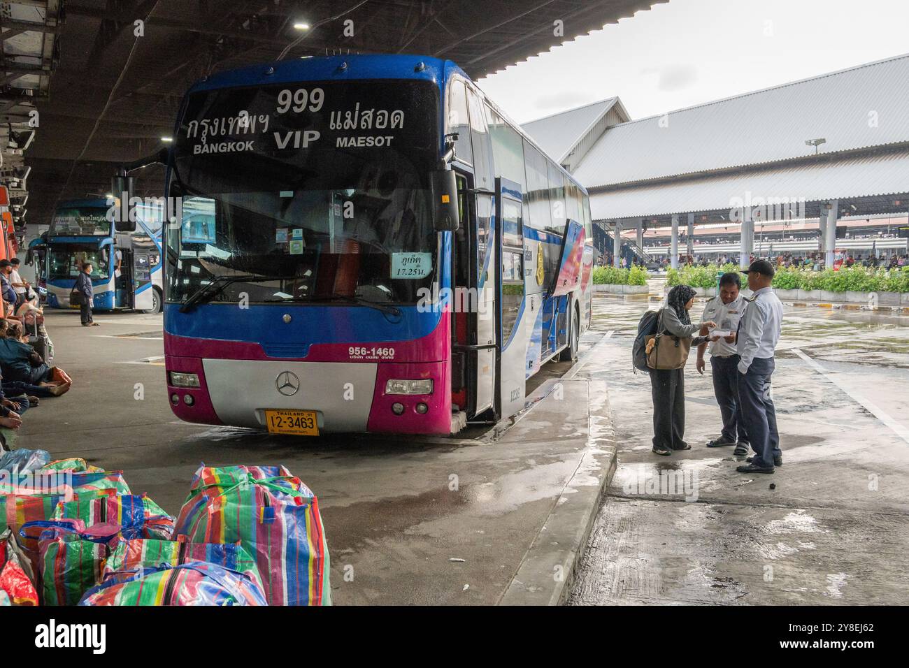 A view of a double-decker at a departure time with luggage outside, and ...