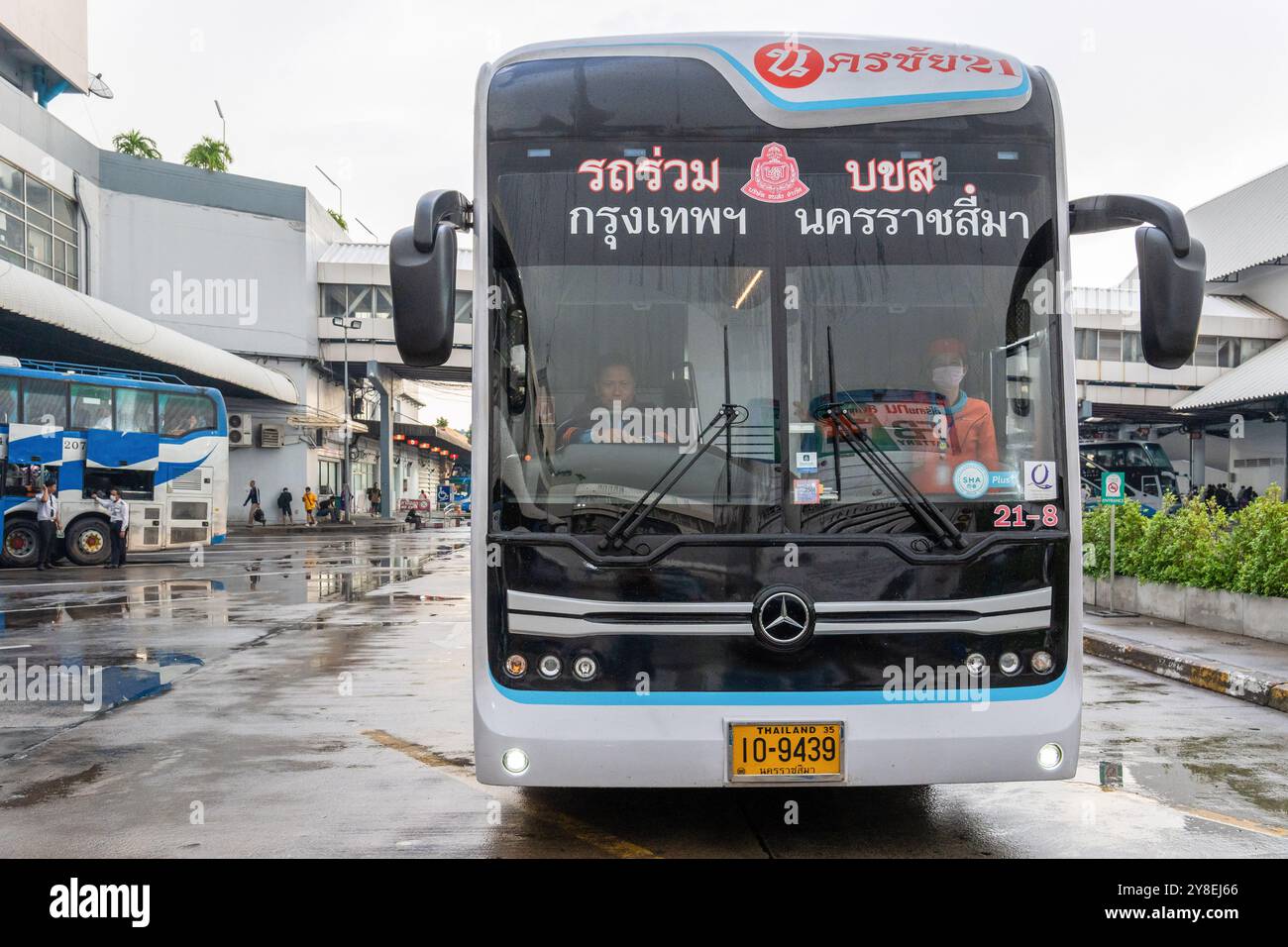 A close-up of a double-decker bus driver with on his side a bus hostess ...