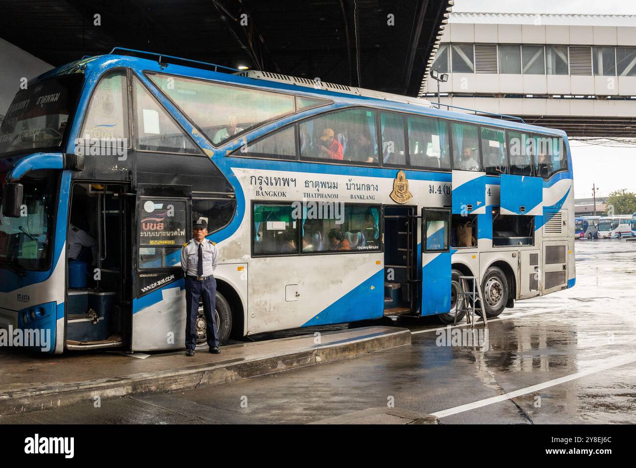 A view of a double-decker bus with its driver standing in front, at Mo ...
