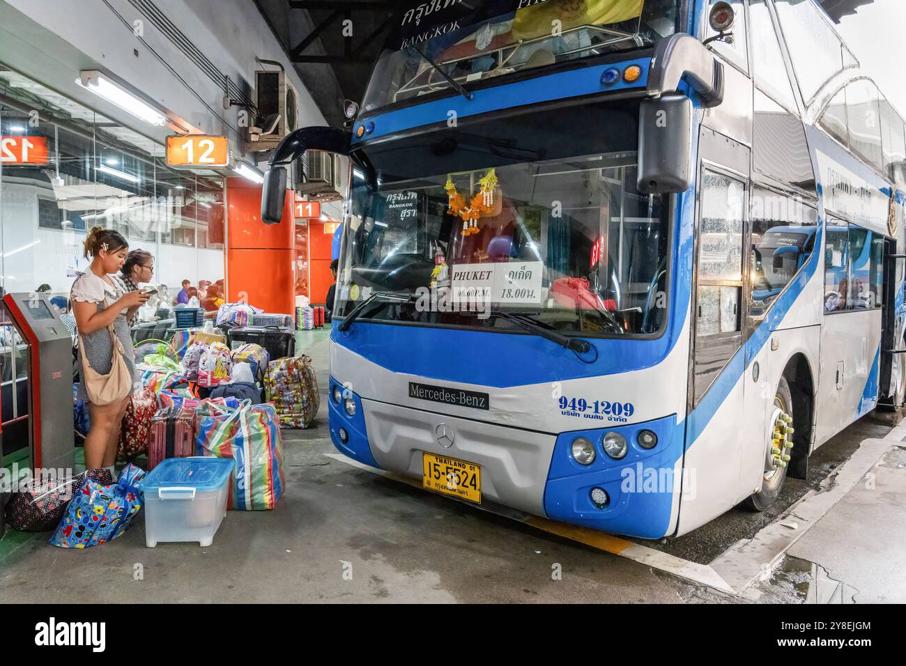 People who are going to Phuket are seen waiting to get in a double ...