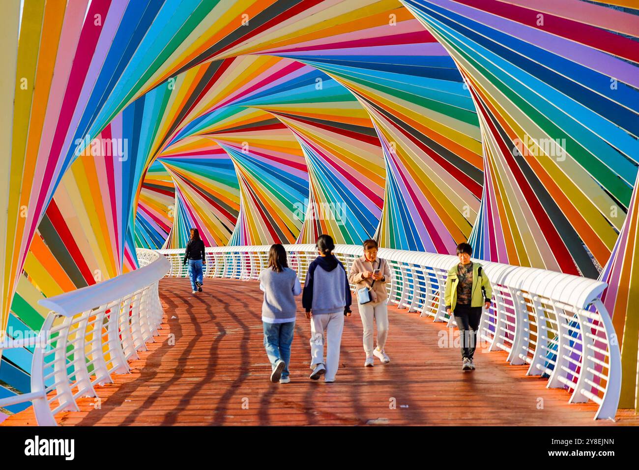 QINGDAO, CHINA - OCTOBER 5, 2024 - Tourists visit the Rainbow Bridge by ...