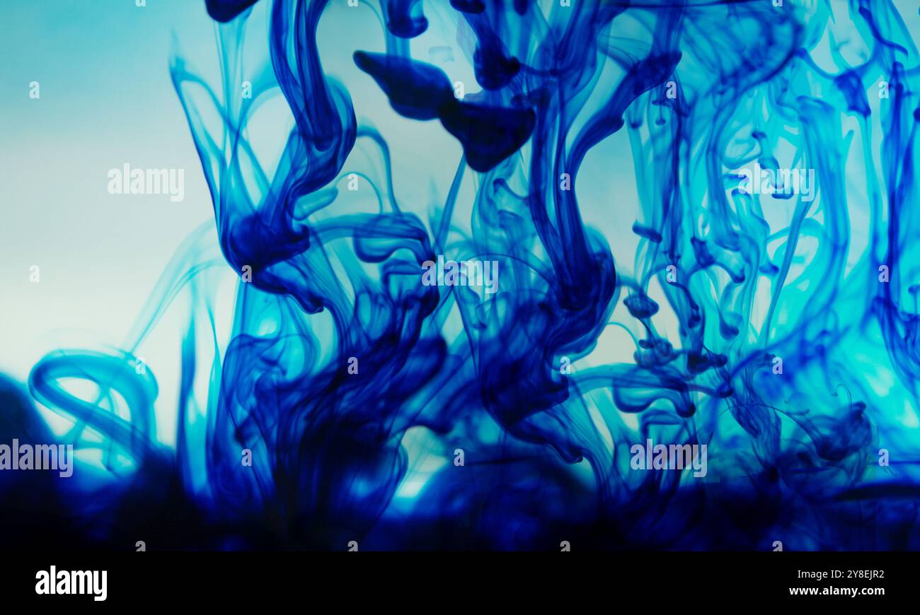 Abstract illustration of blue color acrylic ink in water against white ...
