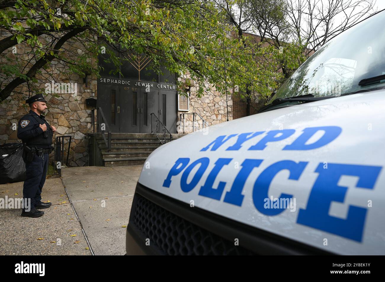An NYPD office stands outside the Sephardic Jewish Center as a measures ...
