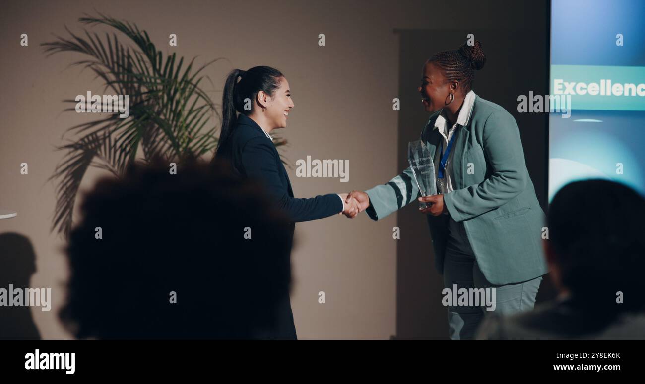 Business women, handshake and smile for prize, congratulations or ...