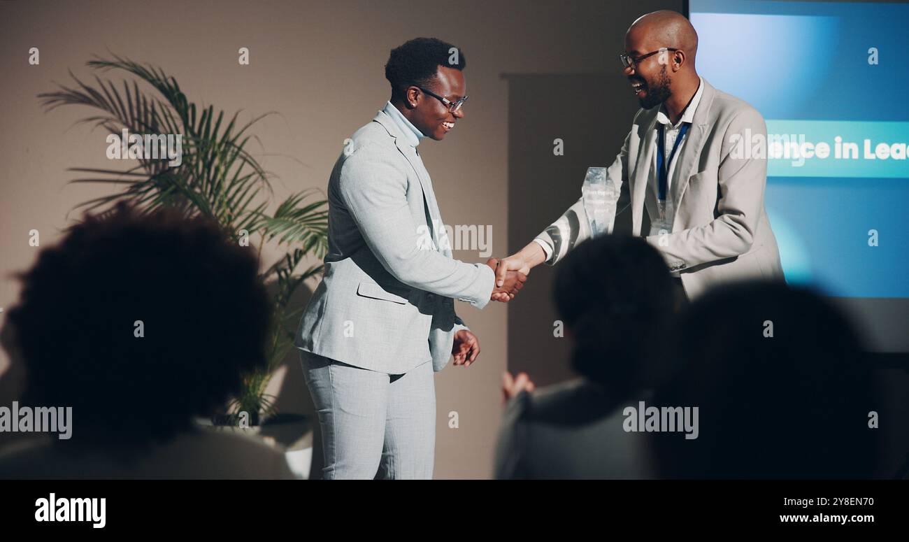 Handshake, award and smile of men, seminar and congratulations for ...