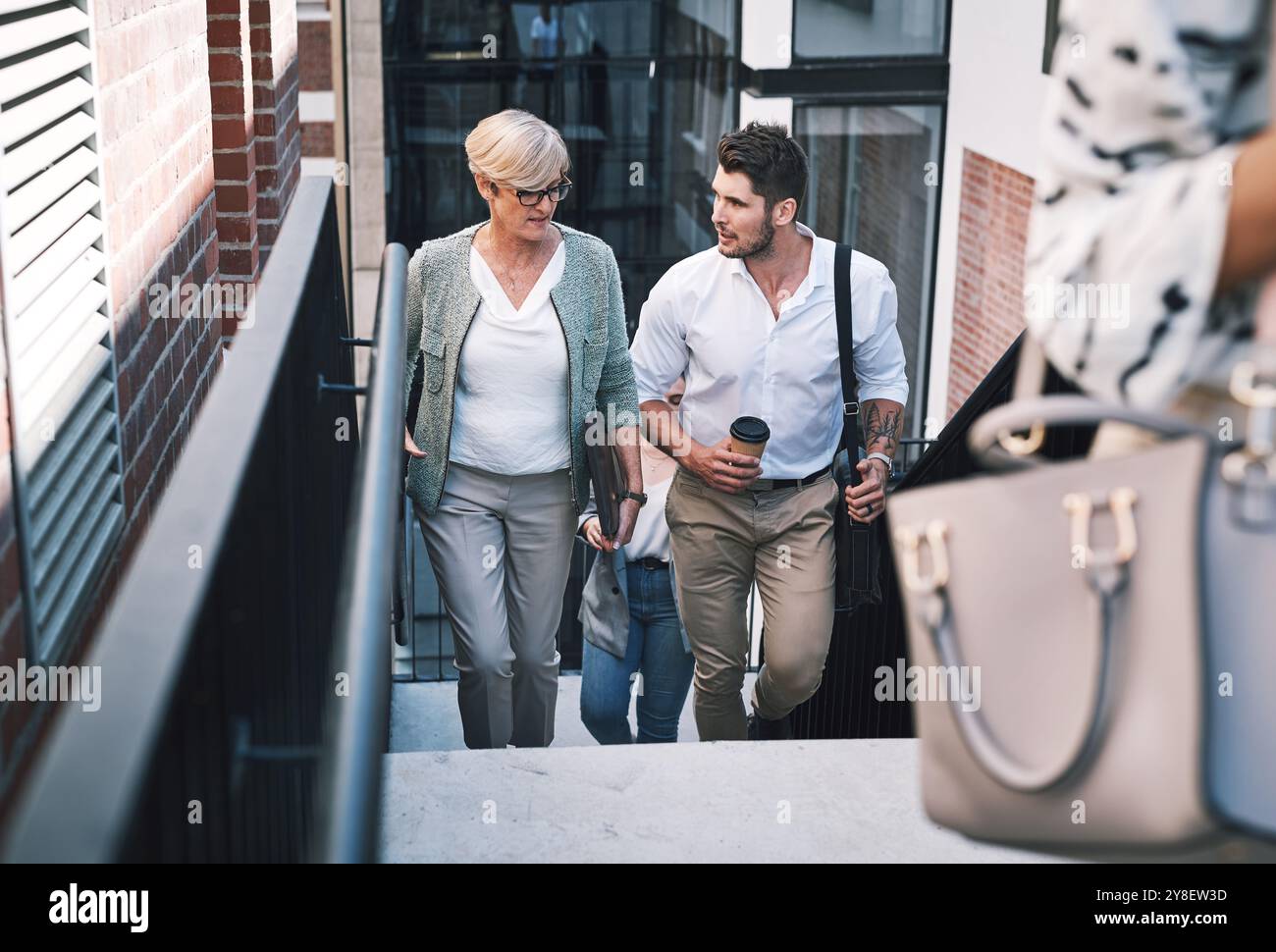 Business people, walking and discussion on stairs, networking and ...