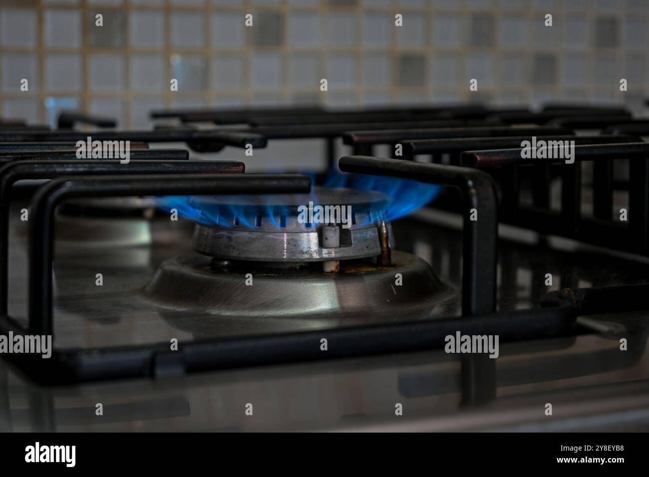 Single burner on a natural gas stove top is lit and burning blue Stock ...