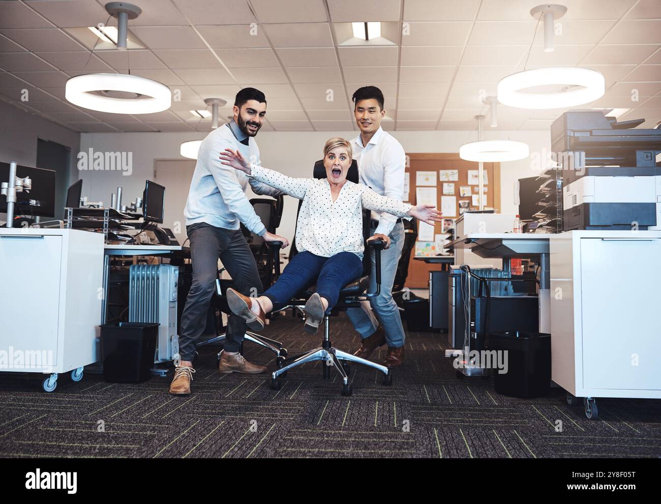 Pushing, chair and colleagues in office, ride and celebration for work ...