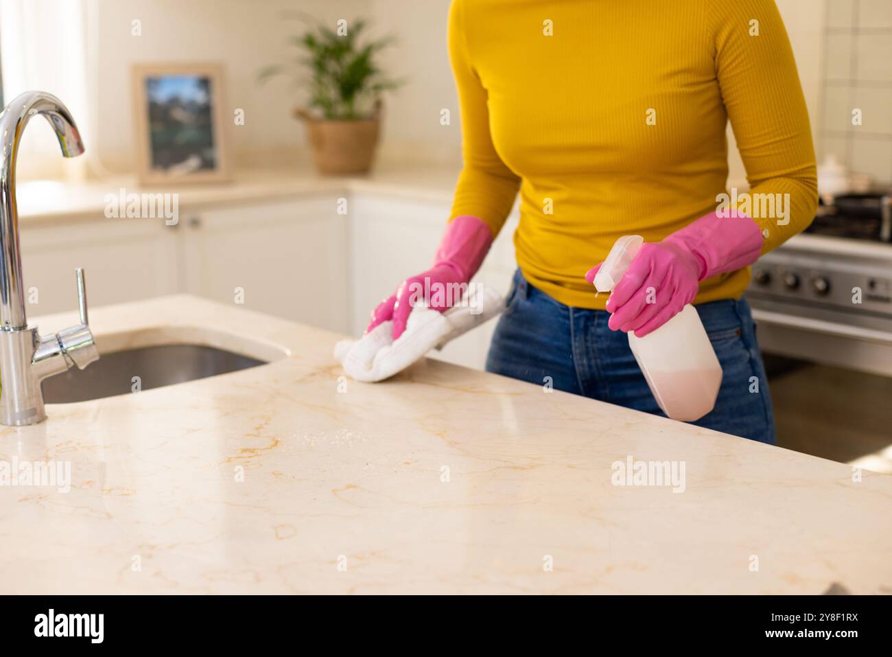 Biracial woman cleaning in kitchen hi-res stock photography and images ...